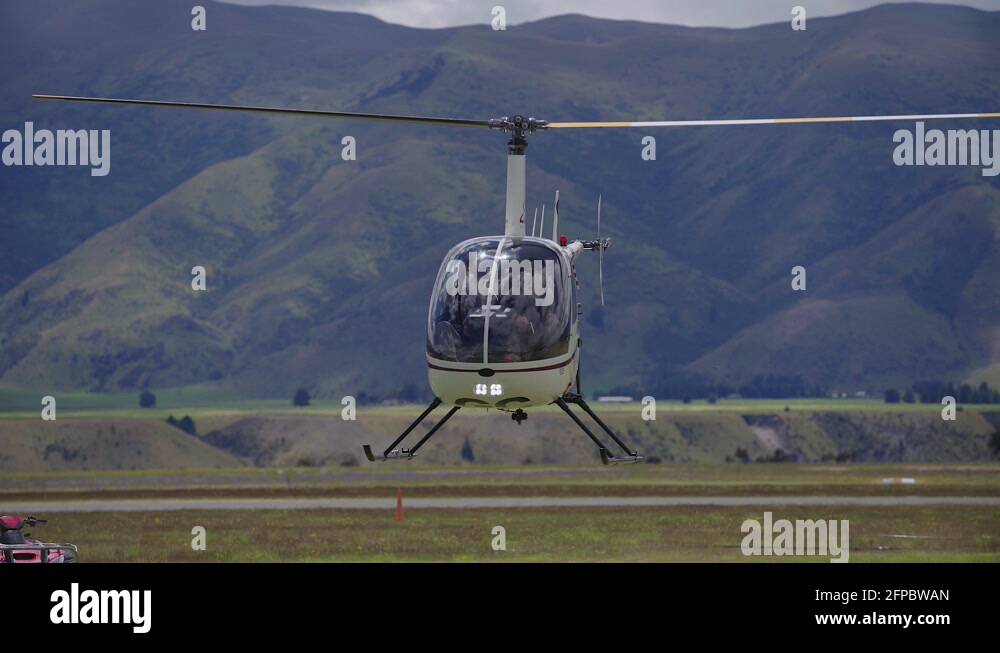 helicopter flying and landing on the ground close up shot wanaka ...