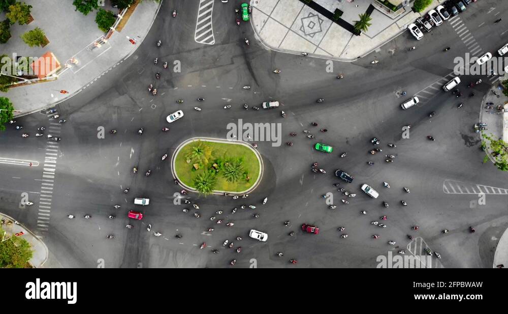 Roundabout in Vietnam, chaotic traffic with motorbikes from top view ...
