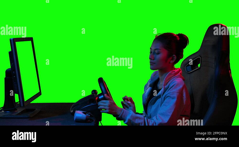 Pro gamer playing in car racing game over green screen background Stock ...