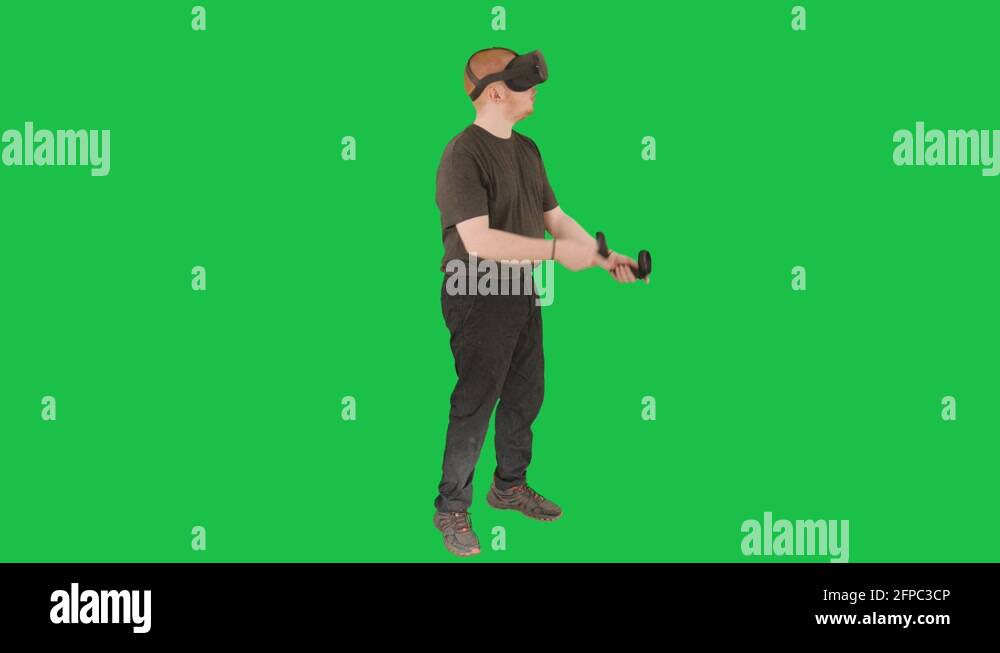 Greenscreen of young guy playing interactive virtual reality computer ...