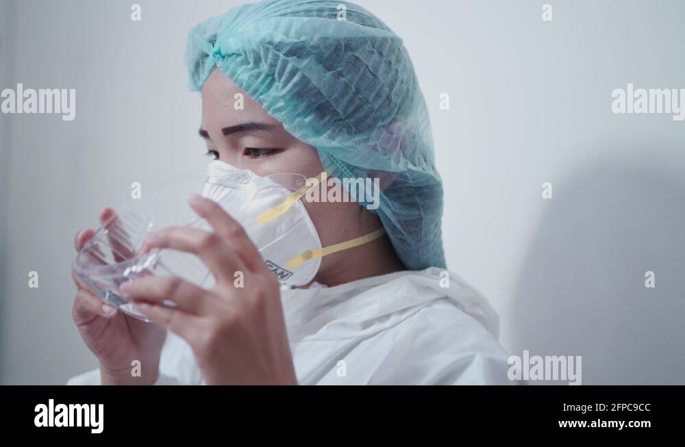 Asian female doctor put on ppe suit, personal protective equipment ...