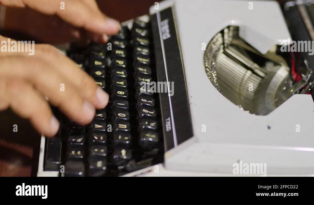 Profile View Of Typist Testing Out Vintage Typewriter With Type Bars In ...