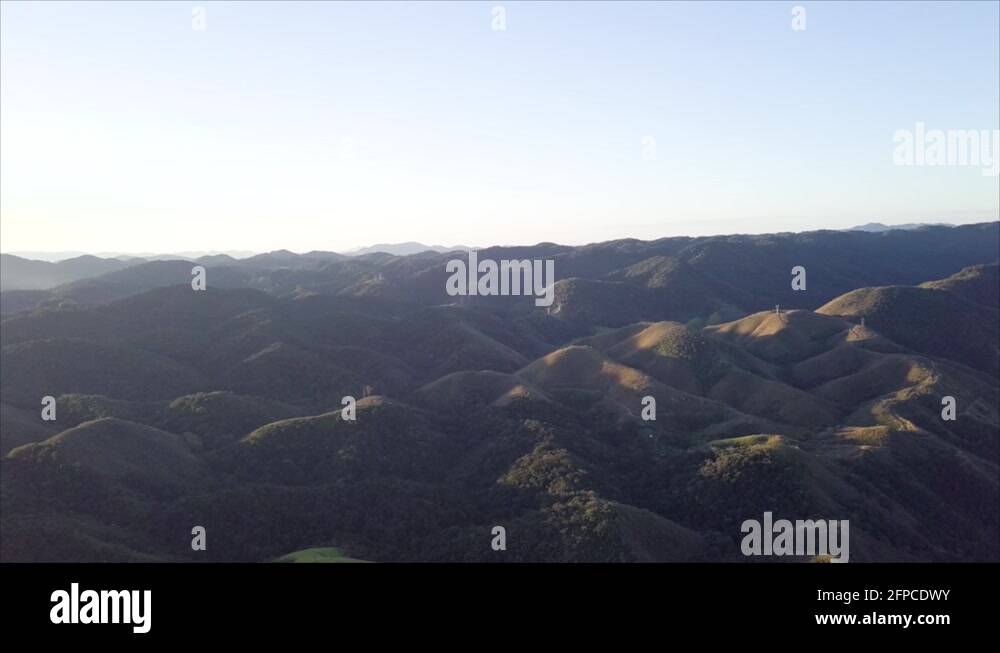 Rugged peaks and hills near Engenheiro Paulo de Frontin, Brazil. Hazy ...