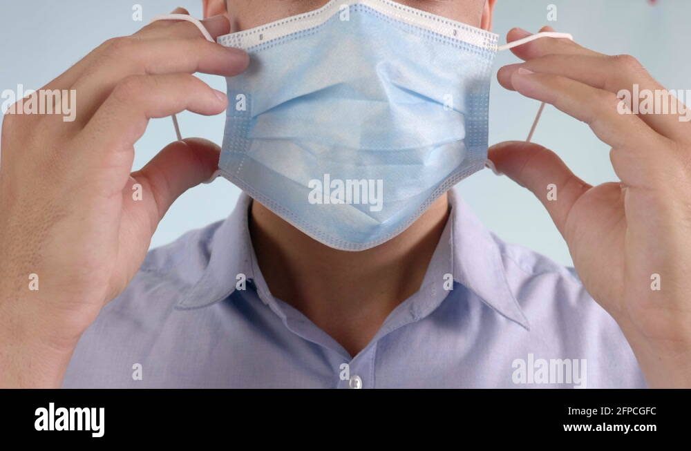 Extreme Closeup of Man Putting Disposable Face Mask Over Mouth and Nose ...