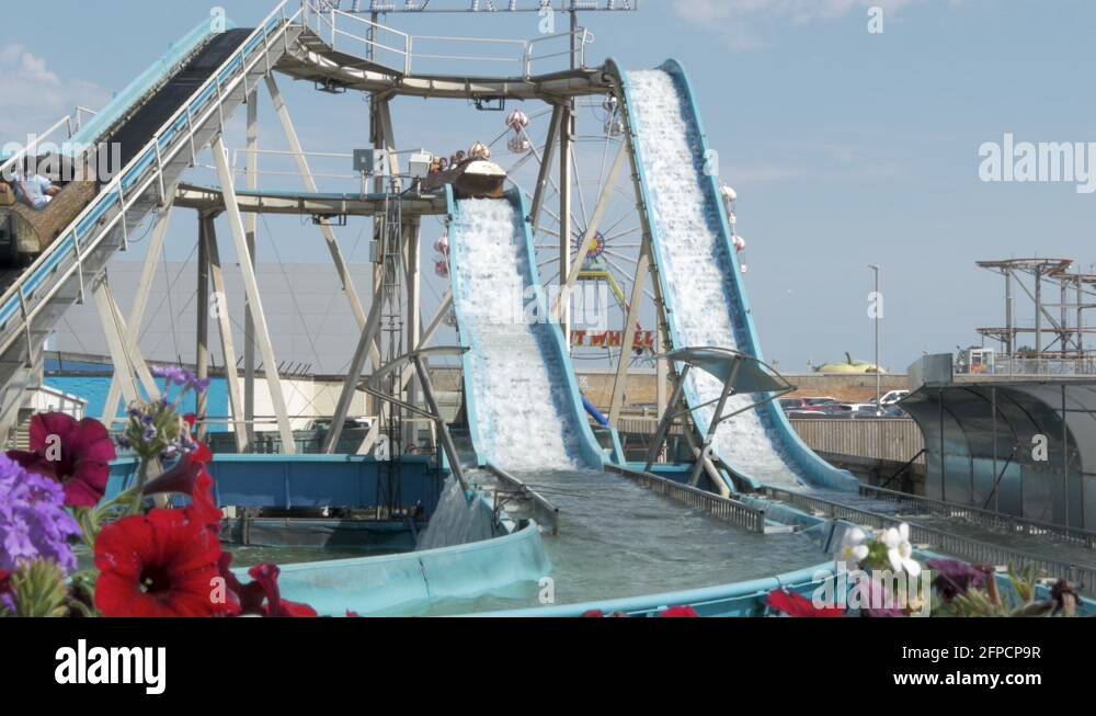 Family day of fun at water park at british coast line, british beach ...