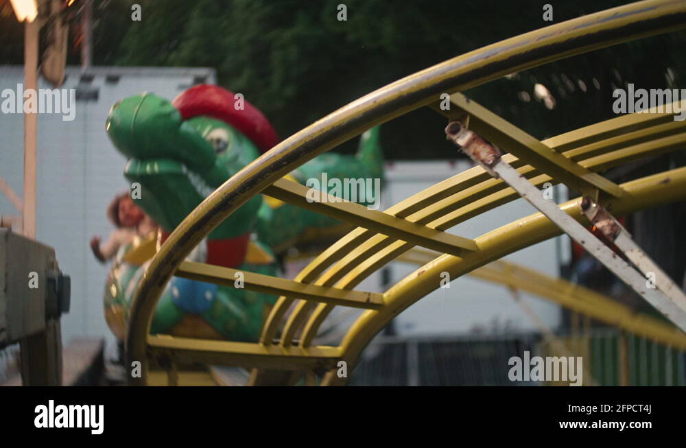 Children riding small roller coaster at carnival, Slow Motion Stock ...