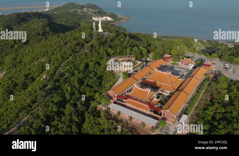 Tilting aerial view of A-Ma Temple and Goddess A-Ma Statue in Coloane ...