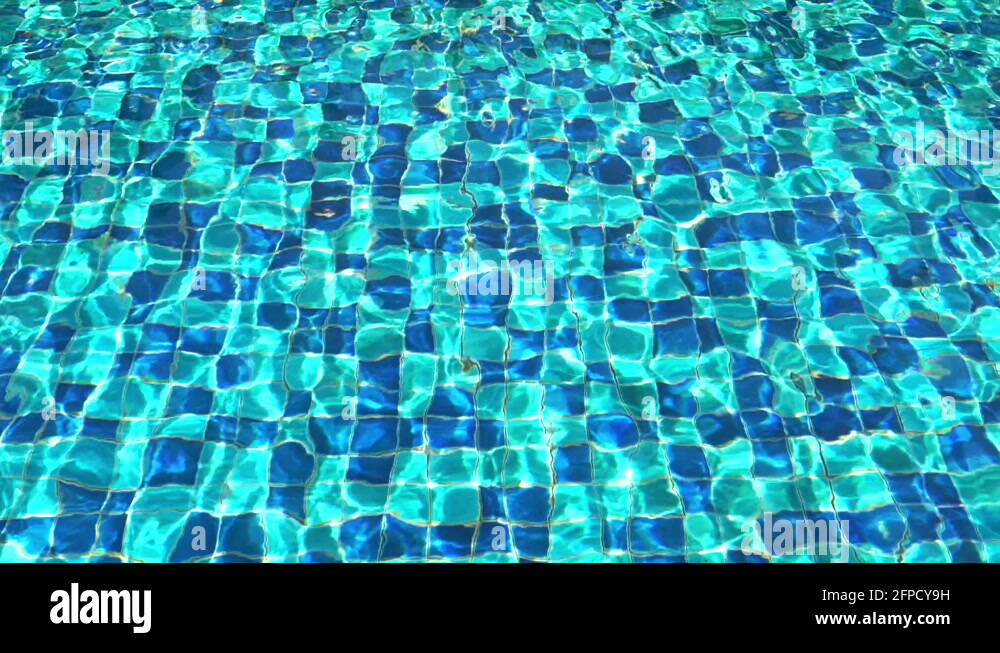 Shiny Water ripples in the swimming pool decorated with tiled mosaic ...