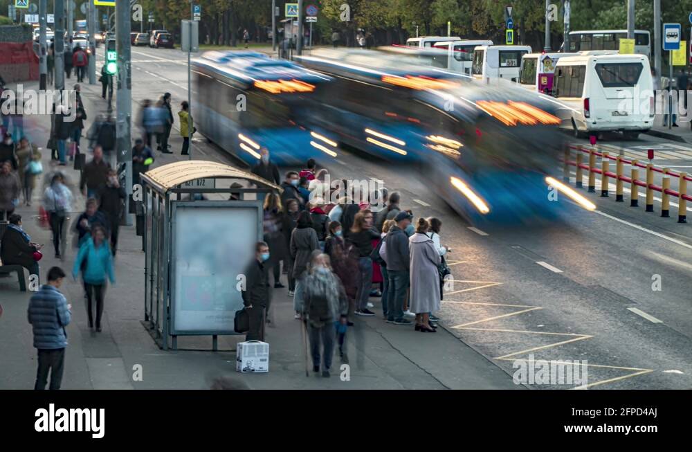 Passengers waiting and boarding buses at the bus terminal, time lapse ...