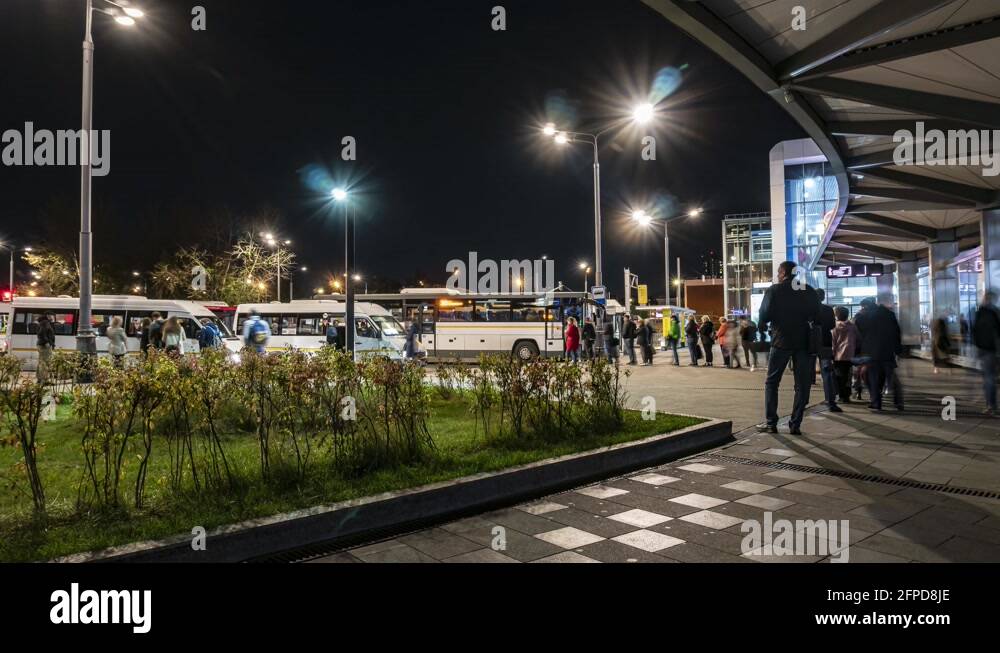 Passengers waiting and boarding buses at the bus terminal, time lapse ...