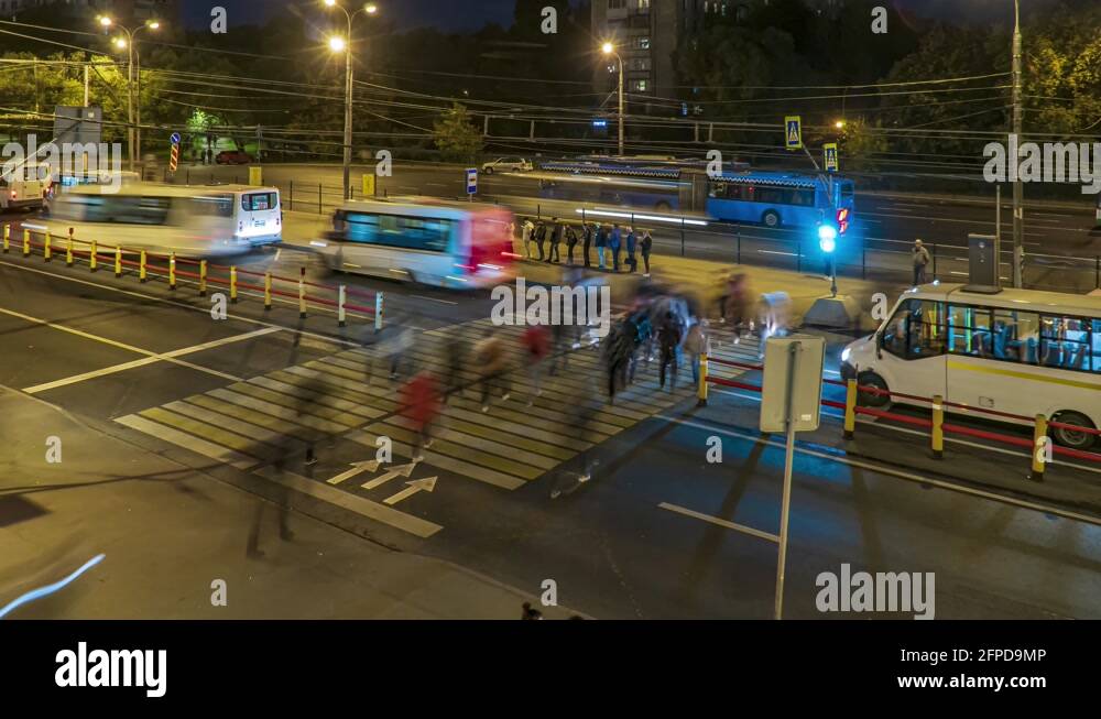 Passengers waiting and boarding buses at the bus terminal, time lapse ...