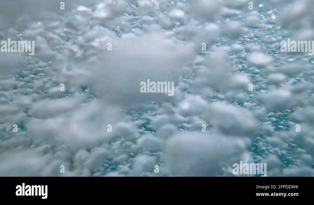 Underwater shot of lots of air bubbles raising out of hot tub pool in ...