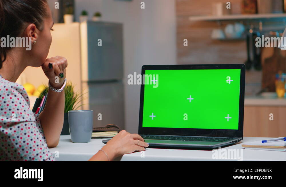 Freelancer looking at green screen monitor Stock Video Footage - Alamy