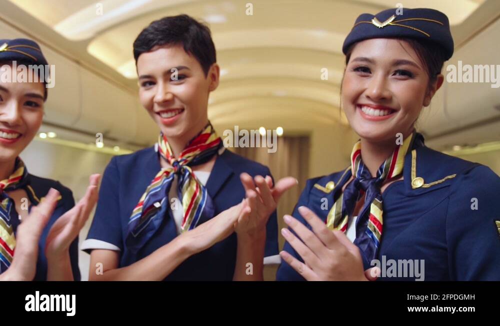 Cabin crew clapping hands in airplane Stock Video Footage - Alamy