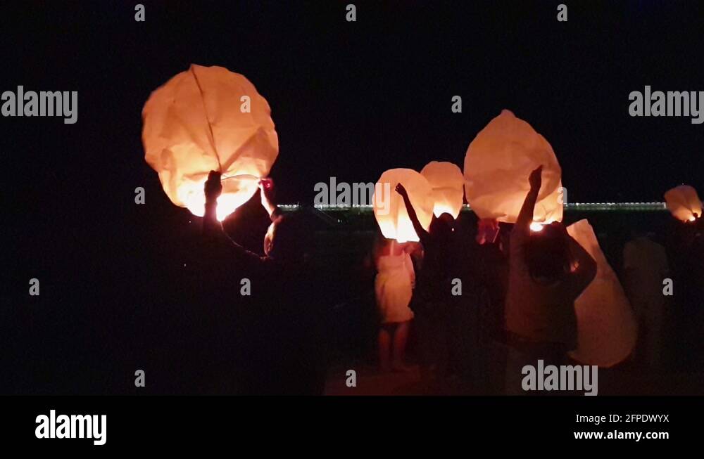 People try to light sky fire lanterns to make them fly at night Stock ...