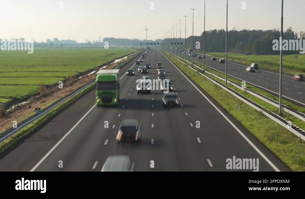Vehicle traffic driving on busy European highway, time lapse zoom out ...