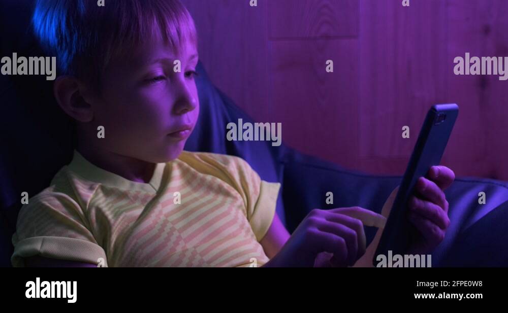 Child with smartphone, 8 years old. Boy typing text messages. Little ...