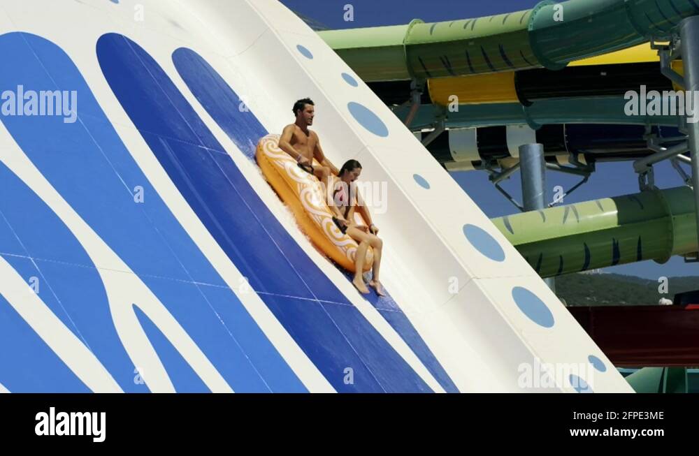 couple slides off the slide in aquapark. slow motion. 4K Stock Video ...