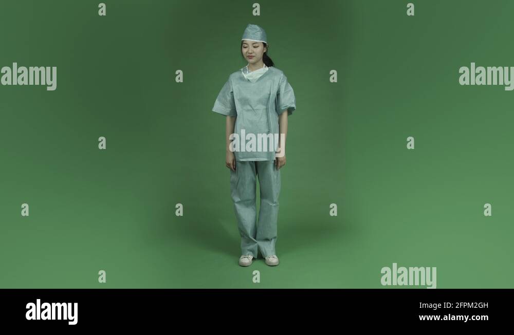 young asian surgeon isolated on green-screen background with a secret ...