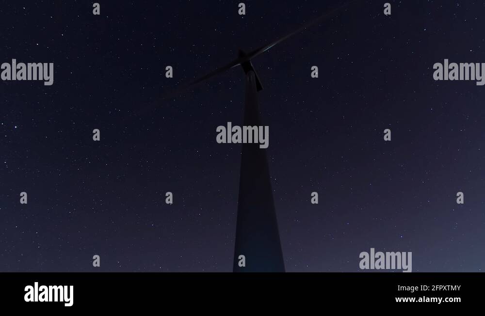 wind mill turbines site on mountain timelapse with stars in the sky ...