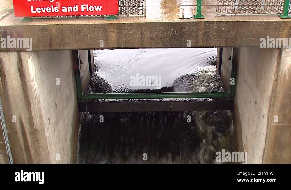Water rushing fast and furious over hydroelectric power dam after storm ...