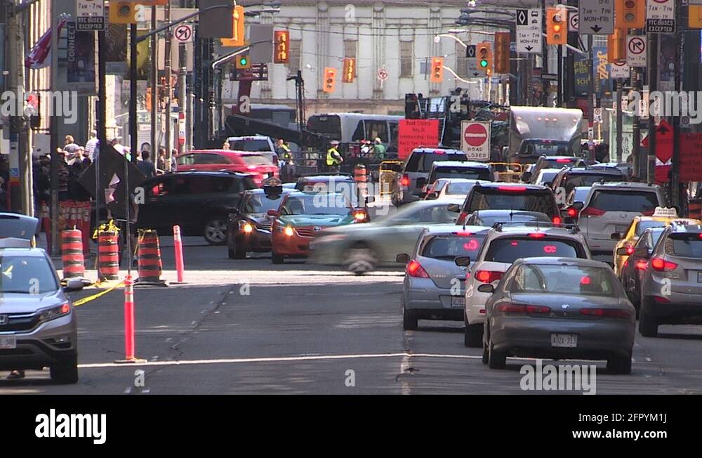 Diverse crowds of tourists in downtown urban city of Toronto on summer ...