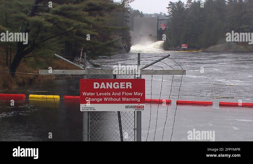Water rushing fast and furious over hydroelectric power dam after storm ...