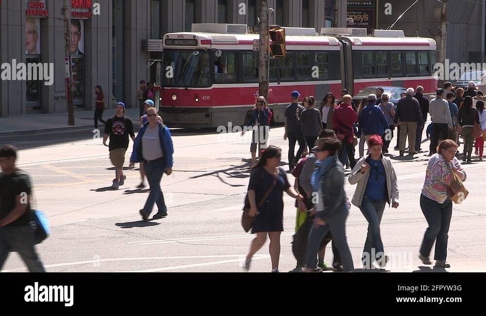 Diverse crowds of tourists in downtown urban city of Toronto on summer ...