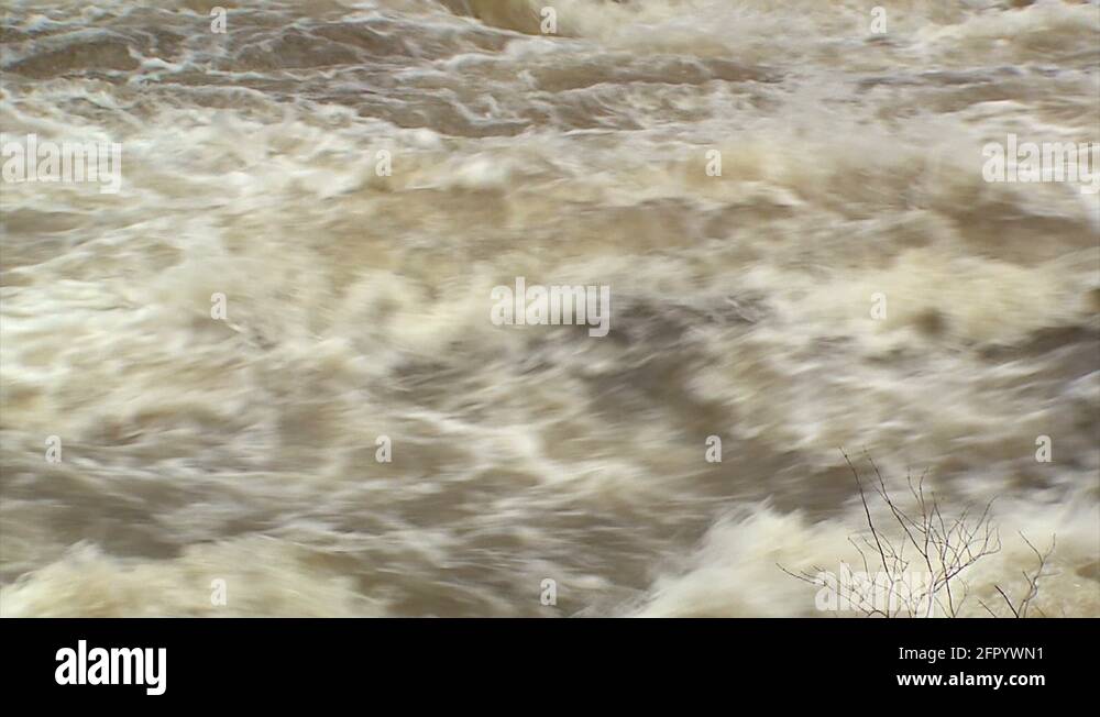 Water rushing fast and furious over hydroelectric power dam after storm ...