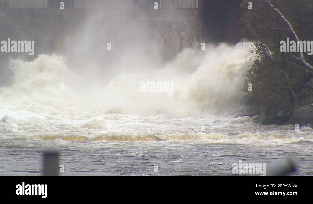 Water rushing fast and furious over hydroelectric power dam after storm ...