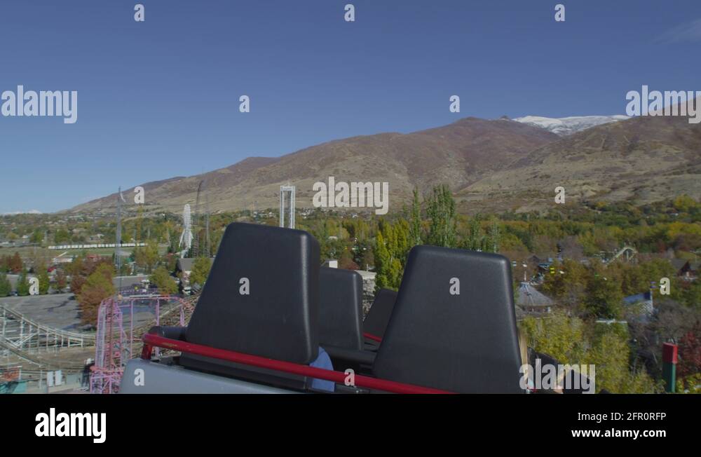 Shot from the back of a rollercoaster riding the twists and turns of ...