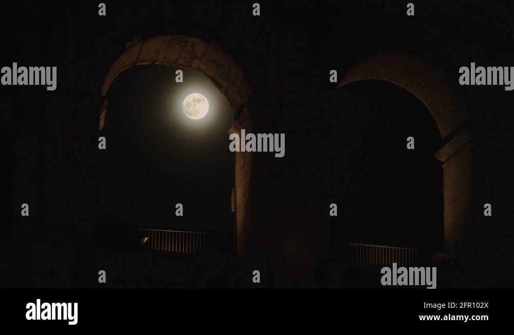 Full moon through arch of Colosseum at night Stock Video Footage - Alamy