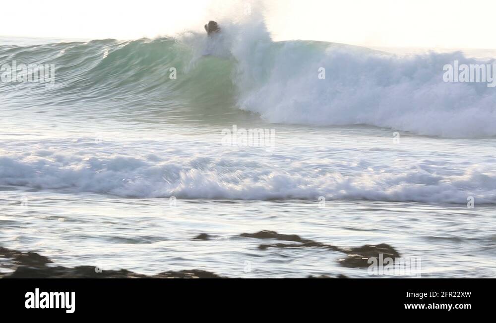 Surfer riding a large point break wave in Jeffreys Bay Stock Video ...