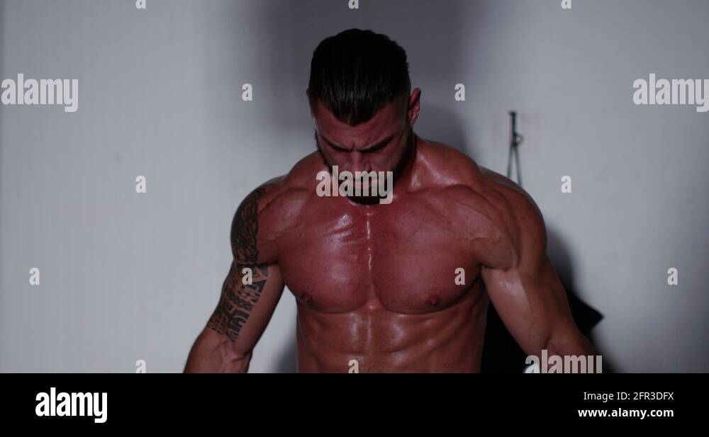 Athlete muscular bodybuilder training on a cable crossover fly pulley ...