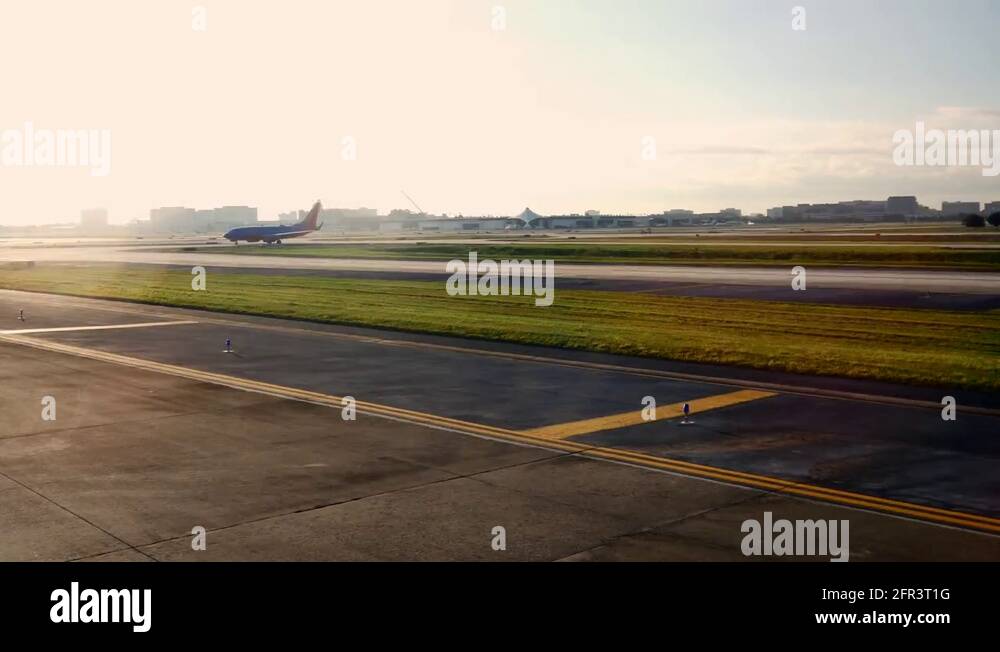 Airplane on runway exits frame through lensflare, 4K Stock Video ...