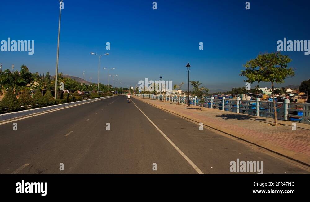 camera moves along empty road past pavement road signs Stock Video ...