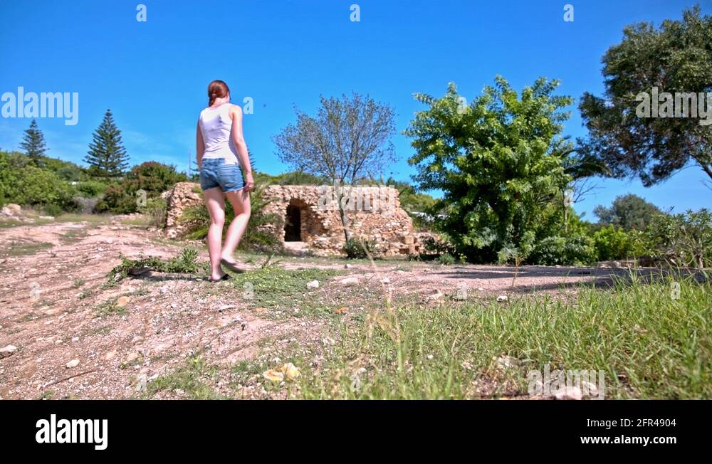 Female person walking towards ancient Carthage building Stock Video ...
