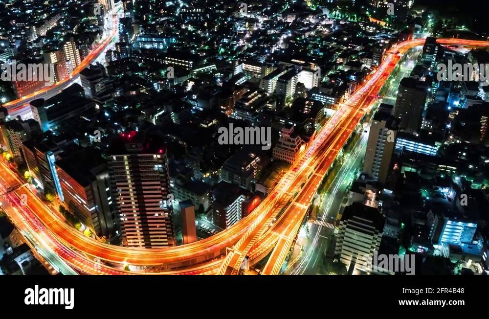 Night turns to day over a massive highway intersection in Tokyo, Japan ...