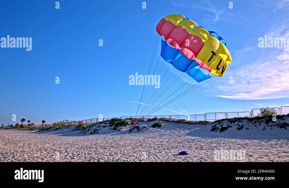Parachute flying in wind on sand beach Stock Video Footage - Alamy