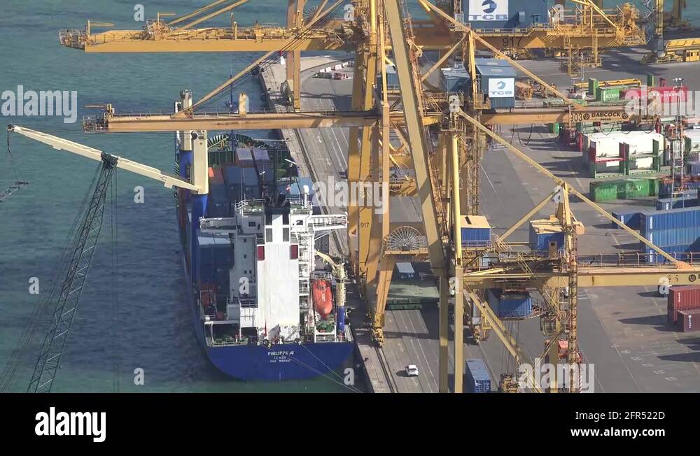 4K Aerial view cargo ship load container international goods crane ...