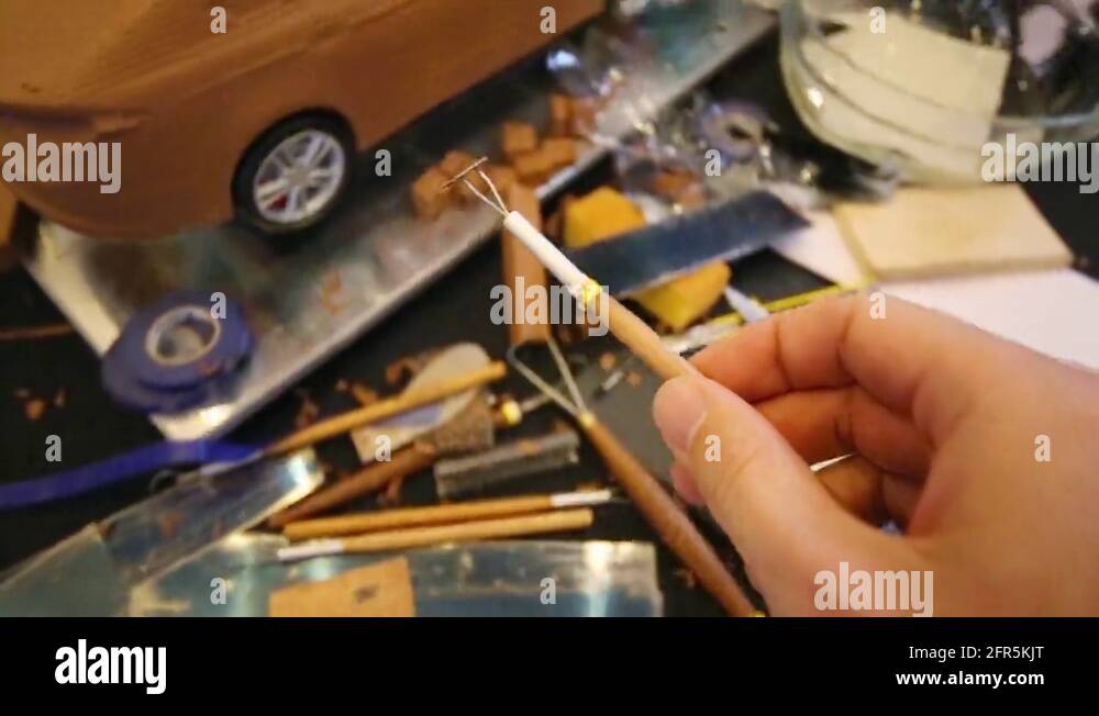 A man puts a spatula to the unfinished clay model of car Stock Video ...