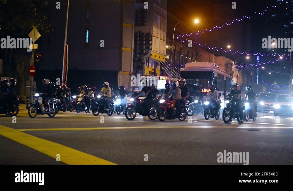 Night loud traffic with motorbikes on central street of KL. Video with ...