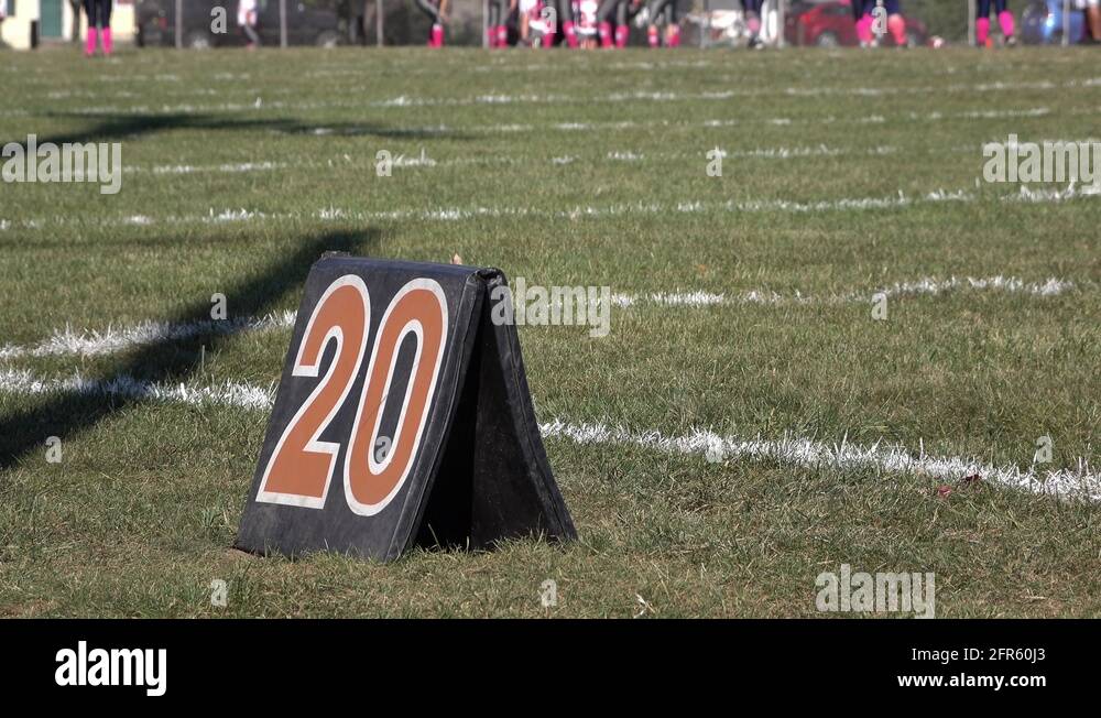 Football field 20 yard line marker with teams in background 4k Stock ...