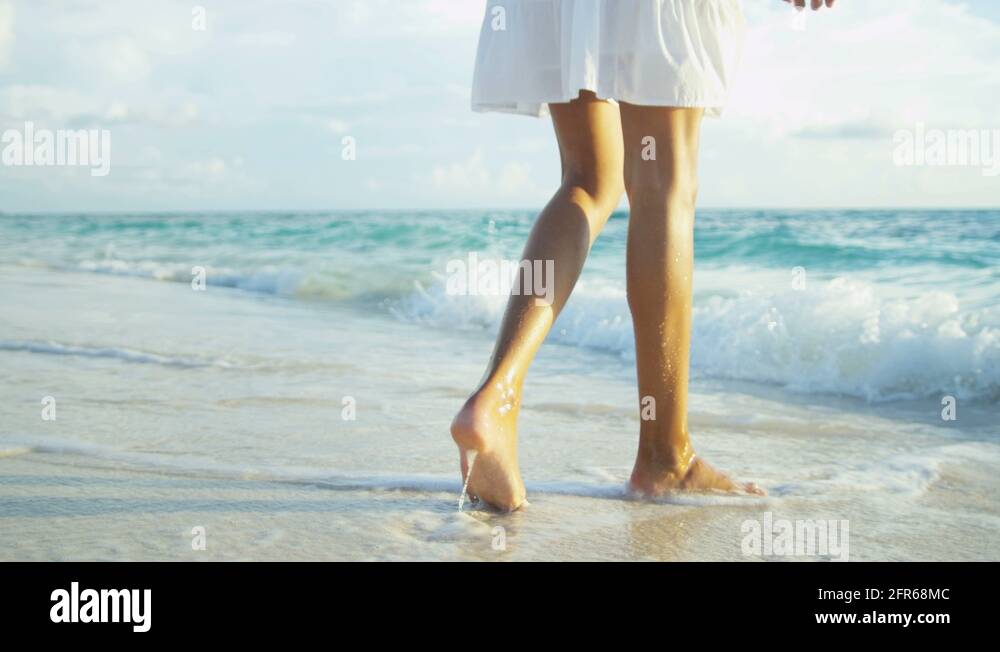 Legs of ethnic Hispanic girl walking barefoot on a tropical beach Stock ...