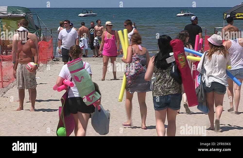 Scorching hot summer beach scenes on sand and water at Wasaga beach ...