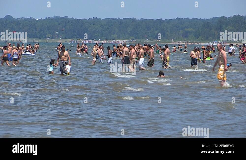 Scorching hot summer beach scenes on sand and water at Wasaga beach ...