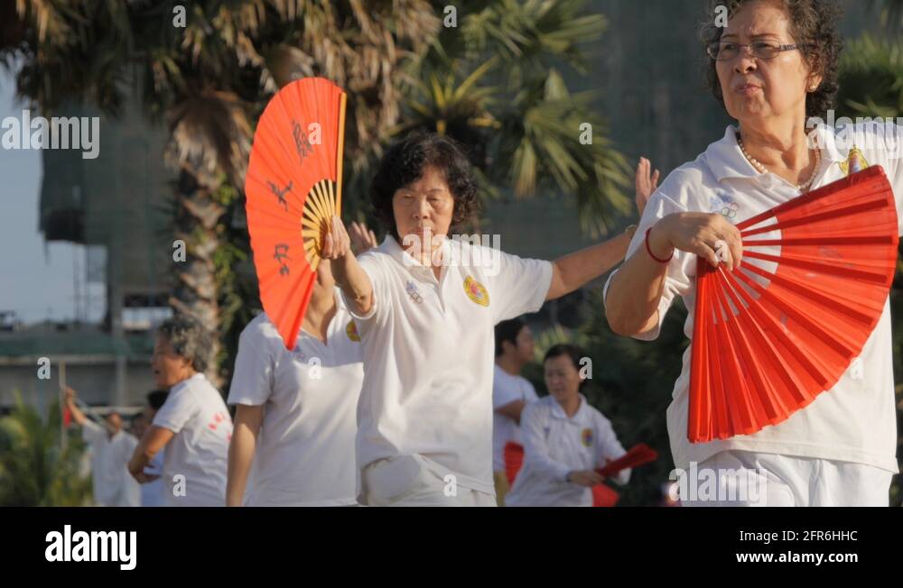 Woman doing slow moving fan dance in olympic stadium,Phnom Penh ...
