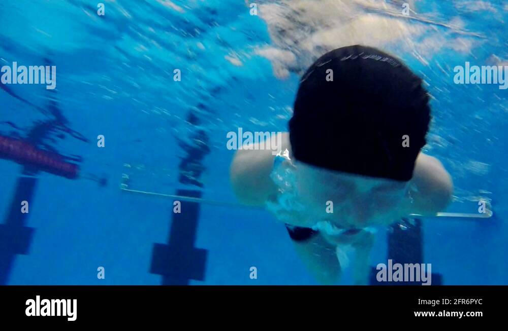 boy teen dives into underwater swimming pool Stock Video Footage - Alamy