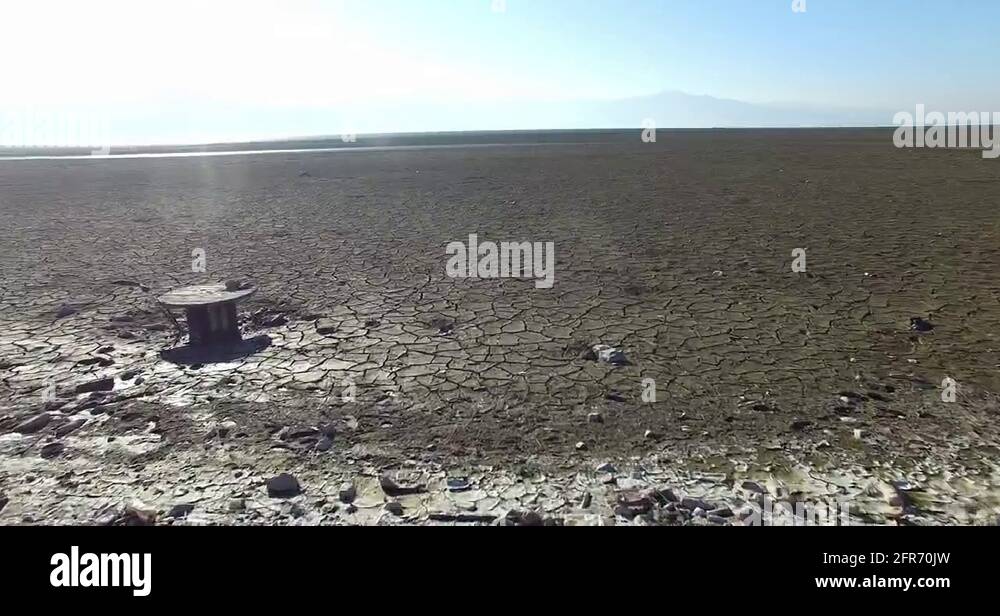 Dry lake bed with natural texture of cracked clay in perspective floor ...