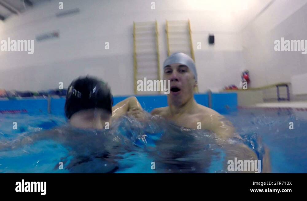 Dad and son in the family swimming pool dive underwater boy and man ...